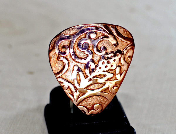 Rococo copper guitar pick with asymmetrical vine design – Nici's Picks